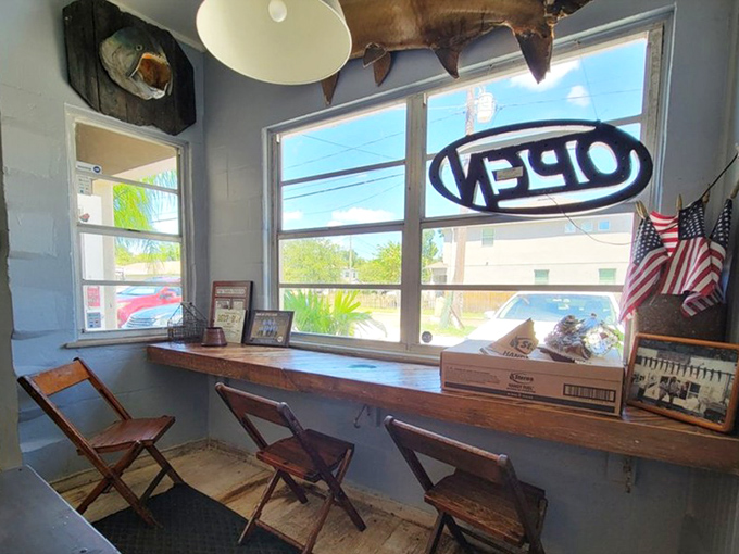 Counter seating with a view of the action&mdash;the best seats in the house. Where fishing tales and culinary magic converge under vintage ceiling fans.