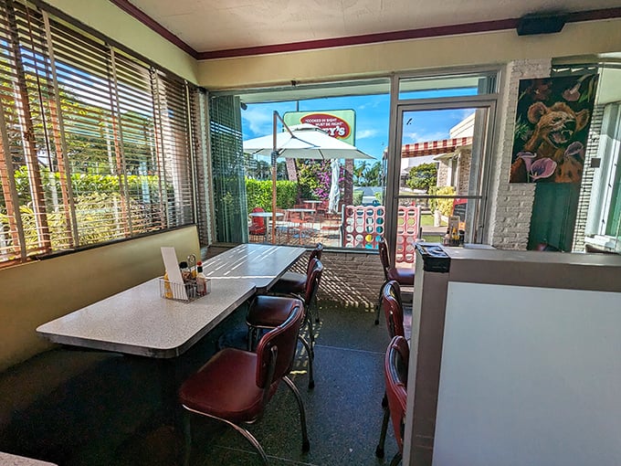 Sunshine streams through windows illuminating booths where countless first dates, business deals, and family celebrations have unfolded since 1950.