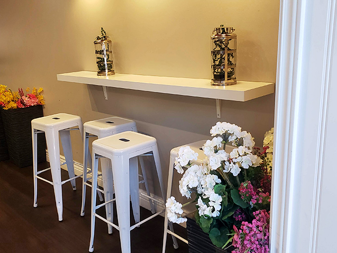 White metal stools and fresh flowers create a small oasis where you can contemplate the important things in life&mdash;like whether to order a second dessert.