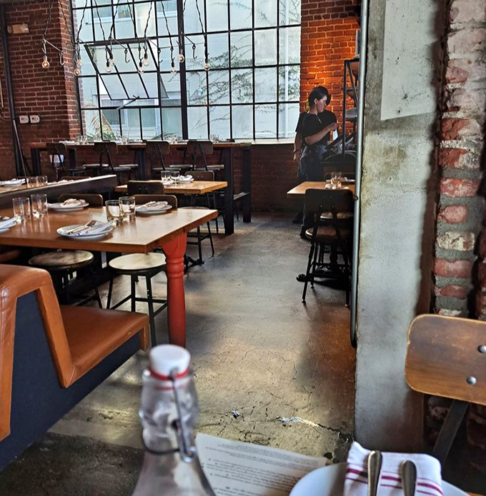 The restaurant's industrial bones create a dining room that feels both intimate and electric&mdash;like eating in the world's coolest factory.