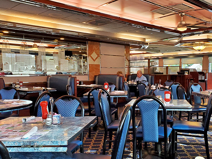 Blue booths that have cradled generations of diners, under lighting that somehow makes everyone look like they belong in a Norman Rockwell painting.