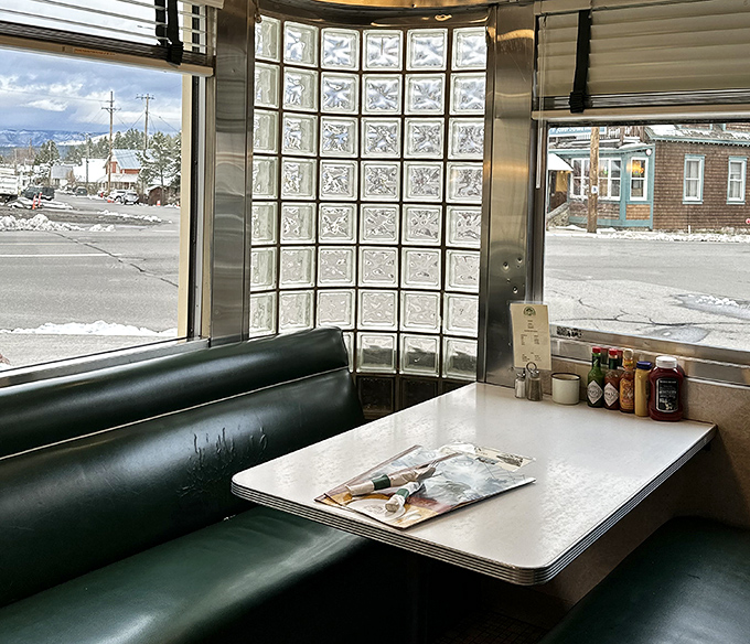 Classic diner booths where countless conversations and comfort food memories have been made, with a view of snowy Truckee outside.