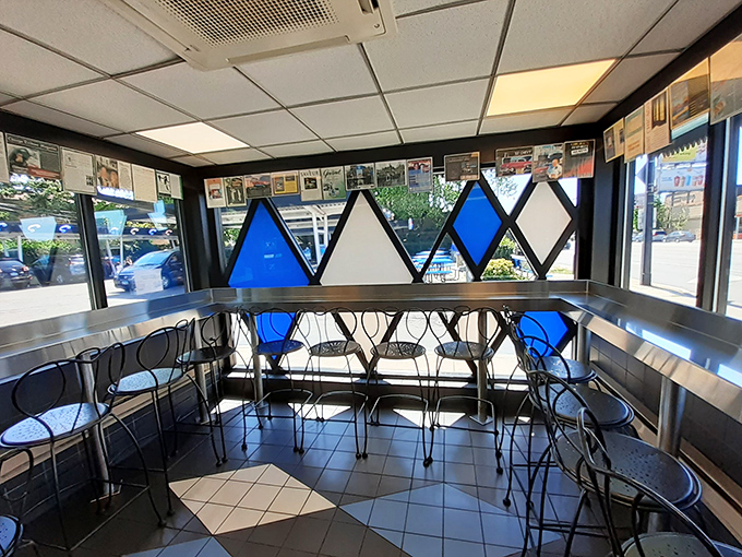 The dining area feels like a time machine with those vintage chairs and memorabilia-lined walls – nostalgia you can actually taste.