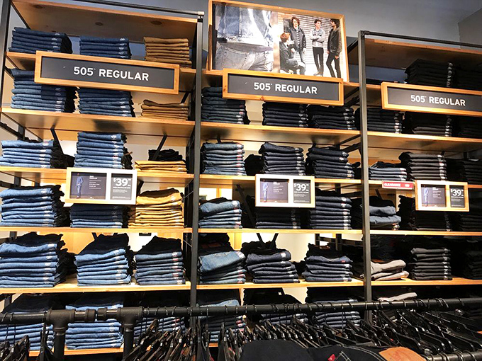 Levi's 505 jeans stacked with military precision. The universal uniform of America, now at prices that won't give your wallet denim blues.