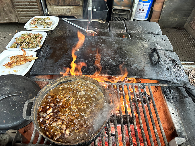 The open flame kitchen isn't just cooking food &ndash; it's performing culinary theater where smoke and fire are essential supporting characters.