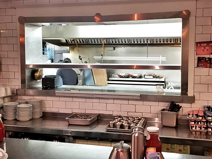 Behind this pass-through window, breakfast dreams are born. The stacks of plates await their delicious destiny.