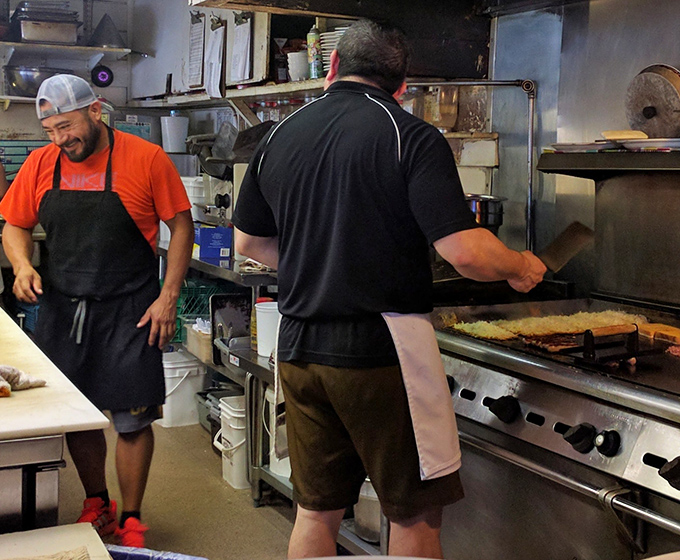 The kitchen crew working their griddle magic &ndash; no smoke and mirrors, just smoke and deliciousness.