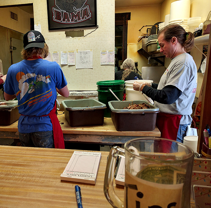 Behind every great barbecue is a kitchen where magic happens. The Alabama sign watches over the smoky alchemy below.