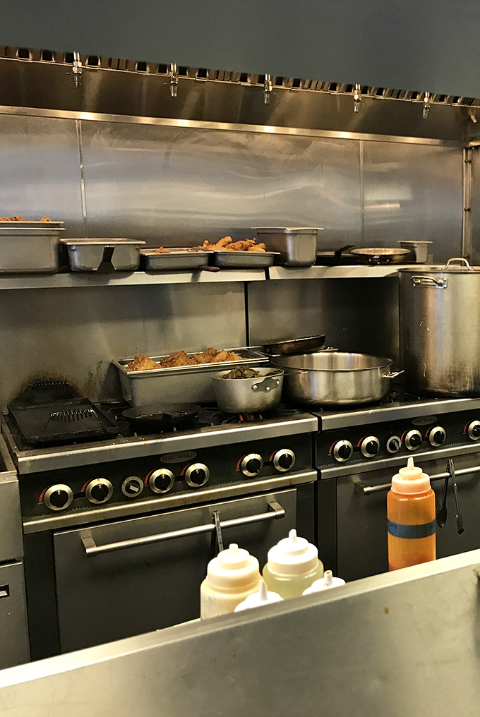 The kitchen battlefield where smoke meets meat in a delicious détente. Those pots contain more happiness than most people experience in a month.