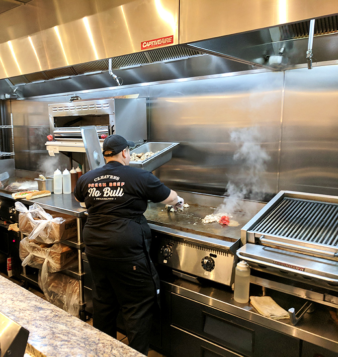 Behind the scenes magic: where ribeye meets grill in a sizzling romance. The chef's shirt says "No Bull" – a philosophy evident in every honest bite.