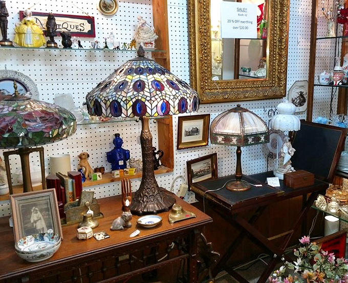 Tiffany-style lamps cast kaleidoscope shadows across antique desks. In the right light, even that butterfly paperweight looks like it might take flight.