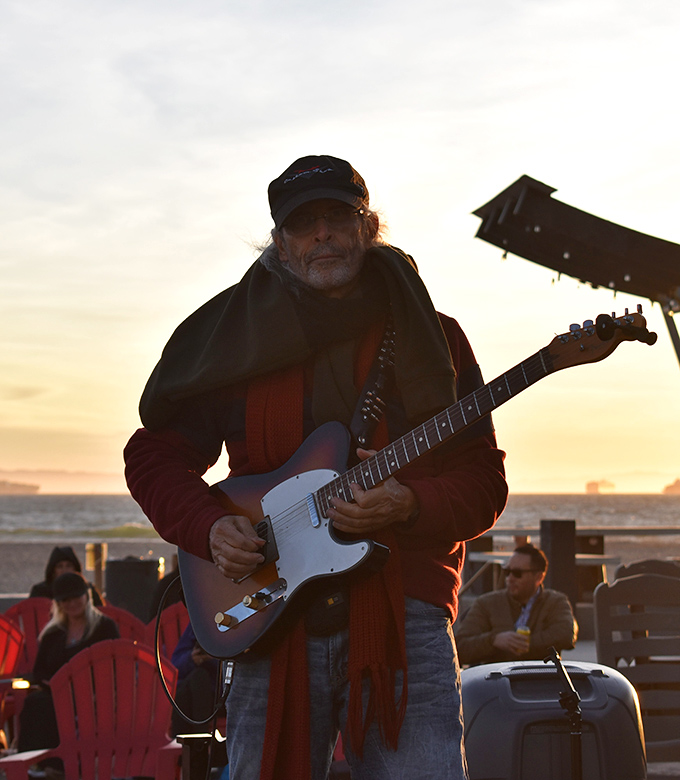 Sunset serenades elevate burgers to a spiritual experience. This guitarist provides the soundtrack to your seaside feast, making memories that outlast the meal.