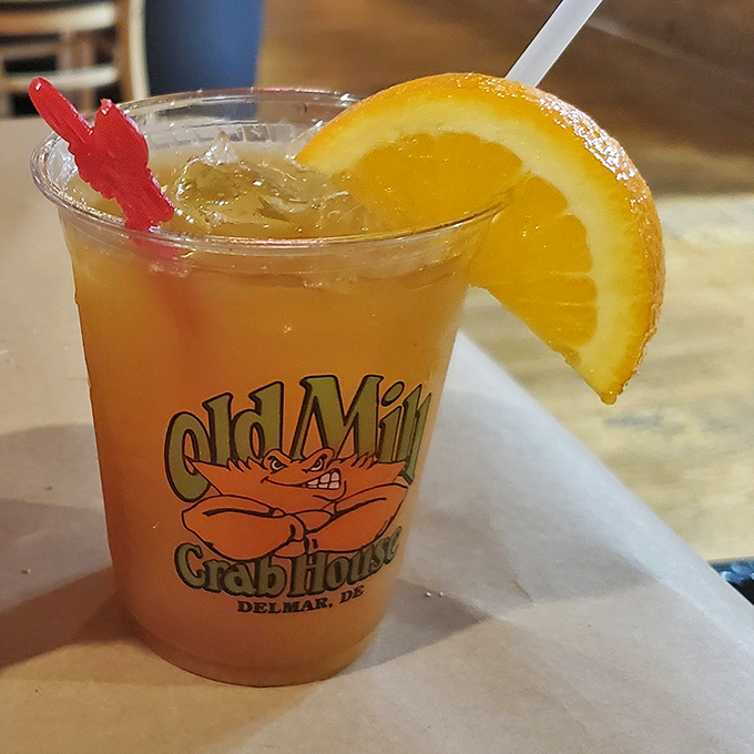 A sunset in a glass with that little red sword&mdash;because every proper drink deserves its own weapon and a slice of citrus armor.