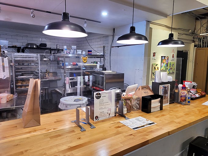 Behind this counter, biscuit wizards perform their buttery magic. The wooden workspace has witnessed countless dough miracles.