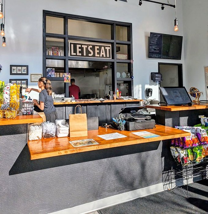 "LET'S EAT" indeed&mdash;the open kitchen design invites you into the sandwich-making process, where craft and care transform simple ingredients into edible art.