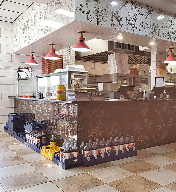 The heart of operations &ndash; where orders transform from scribbled notes to plates of happiness under blue pendant lights. 