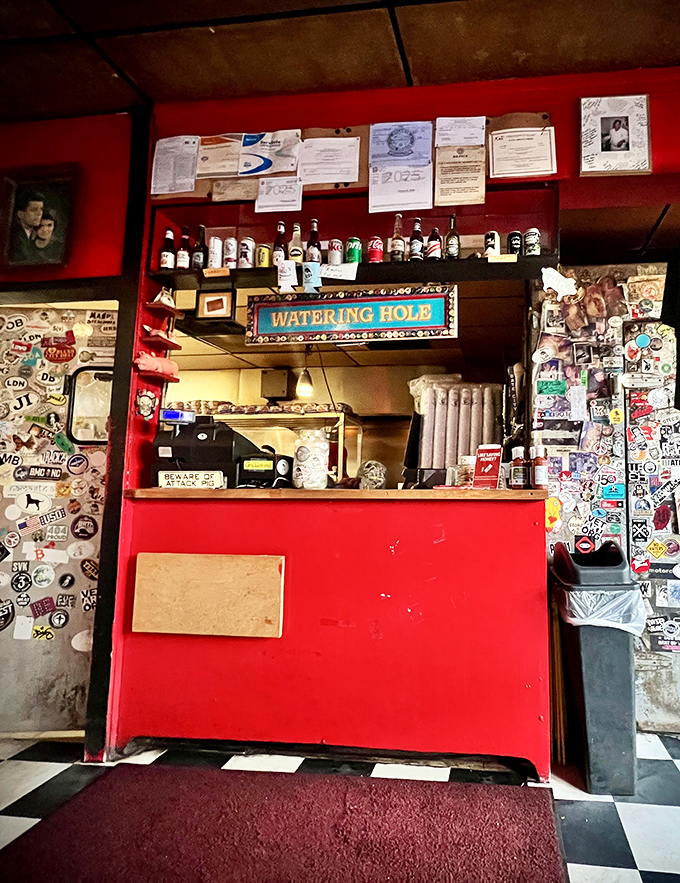 The "Watering Hole" bar area&mdash;where stickers tell stories, bottles stand at attention, and thirst meets its match.