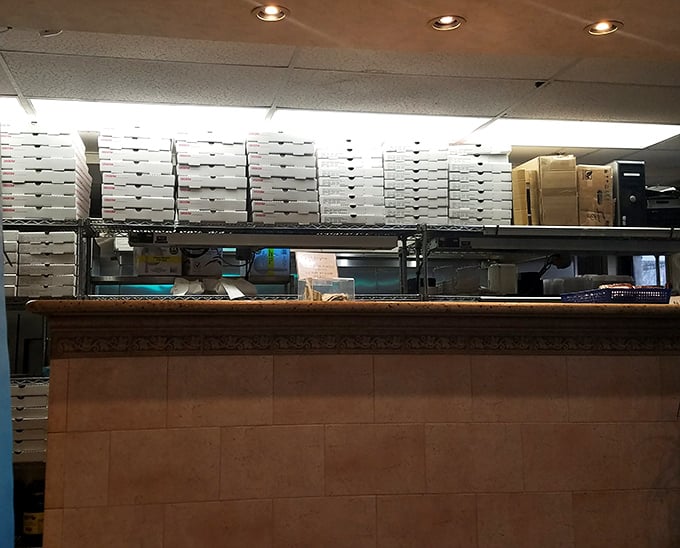 Behind every great pizza is a wall of boxes waiting for their moment. The heart of operations where pizza dreams become delicious reality.