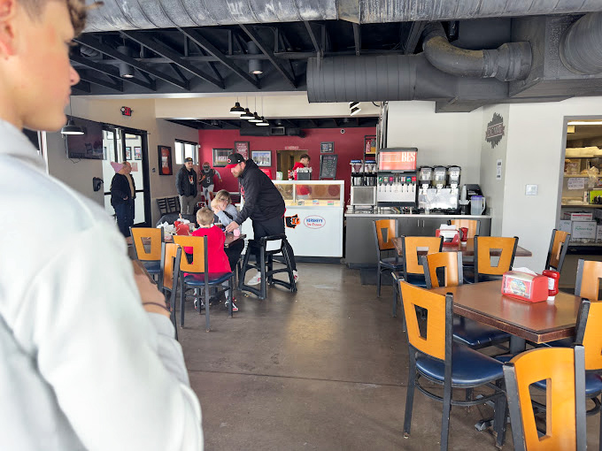 Where BBQ magic happens daily. That red accent wall has witnessed countless "first bite" faces&mdash;the kind that turn strangers into regulars.