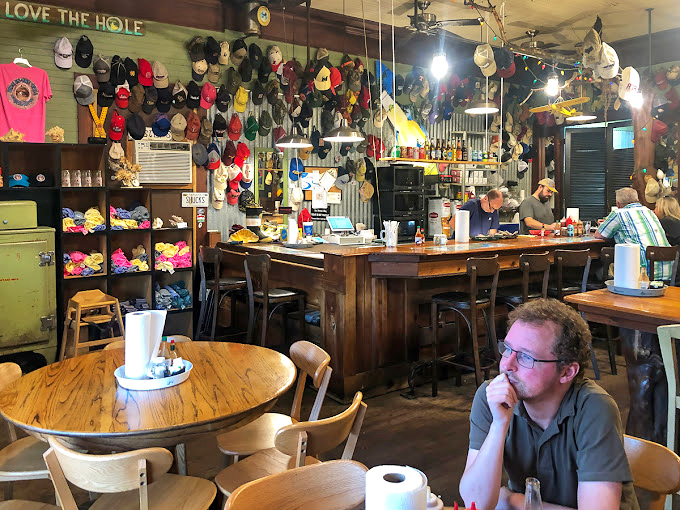 "Love The Hole" proclaims the sign, while hundreds of hats stand witness to meals so memorable that patrons left pieces of themselves behind.