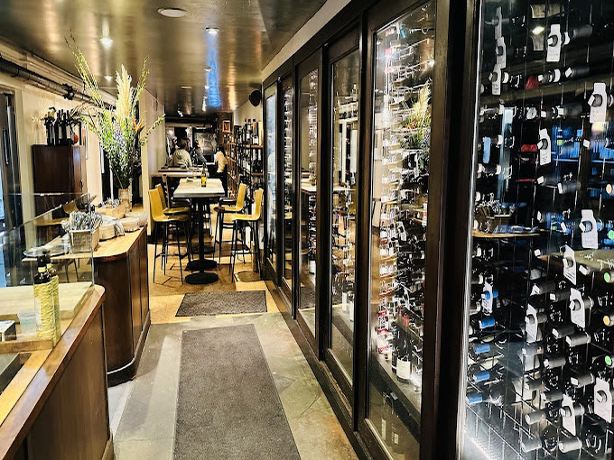 The wine display isn't just storage&mdash;it's a library of liquid stories waiting to be paired with your meal's next chapter.