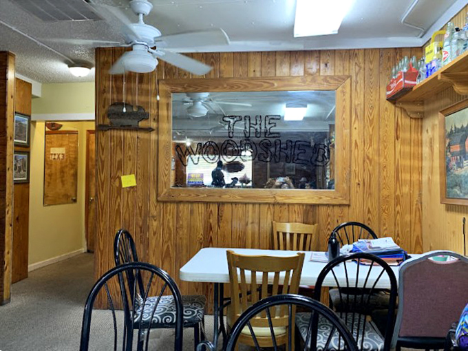 "The Woodshed" dining area offers a cozy corner for savoring your buffet treasures. Wood paneling for days!