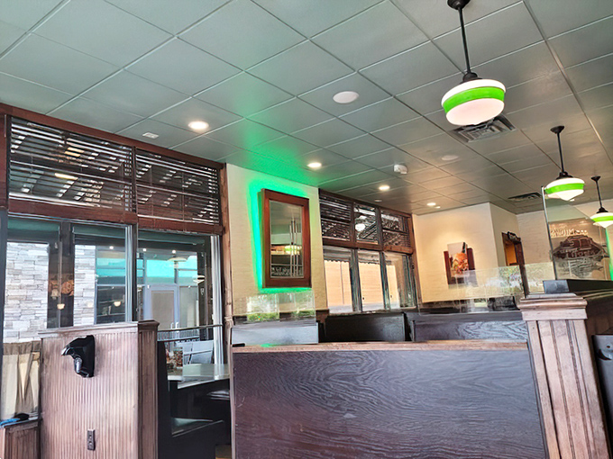 Green-tinged lighting casts a welcoming glow over wooden booths. Even empty, the space feels full of possibilities and pancake potential.