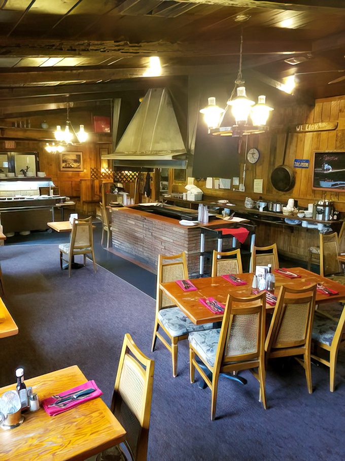 The dining room's wood-paneled charm creates an atmosphere where conversations flow as smoothly as the drinks from the well-stocked bar.