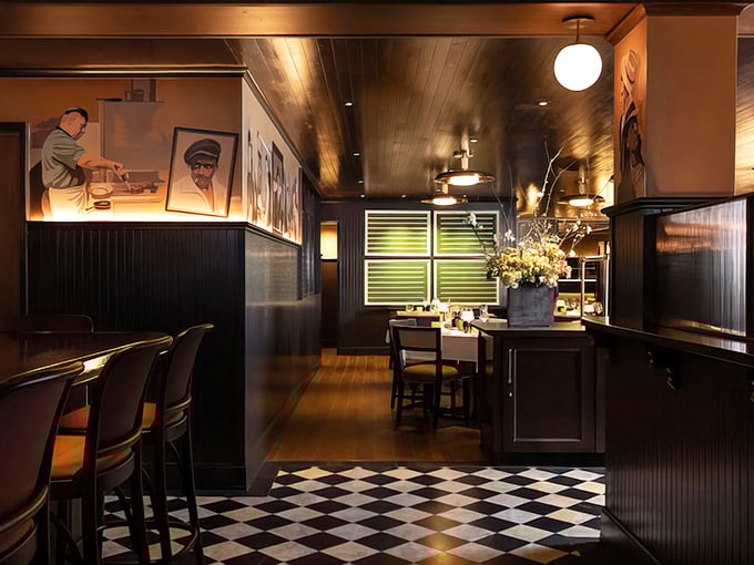 Dark wood paneling, checkered floors, and vintage lighting create an atmosphere that whispers, "Important conversations happen here&mdash;preferably over scotch."