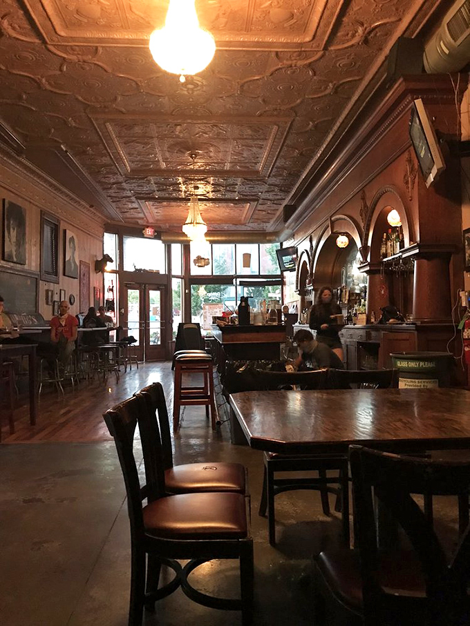 Vintage chandeliers cast a warm glow over wooden tables where memories are made between bites of comfort food and sips of local beer.