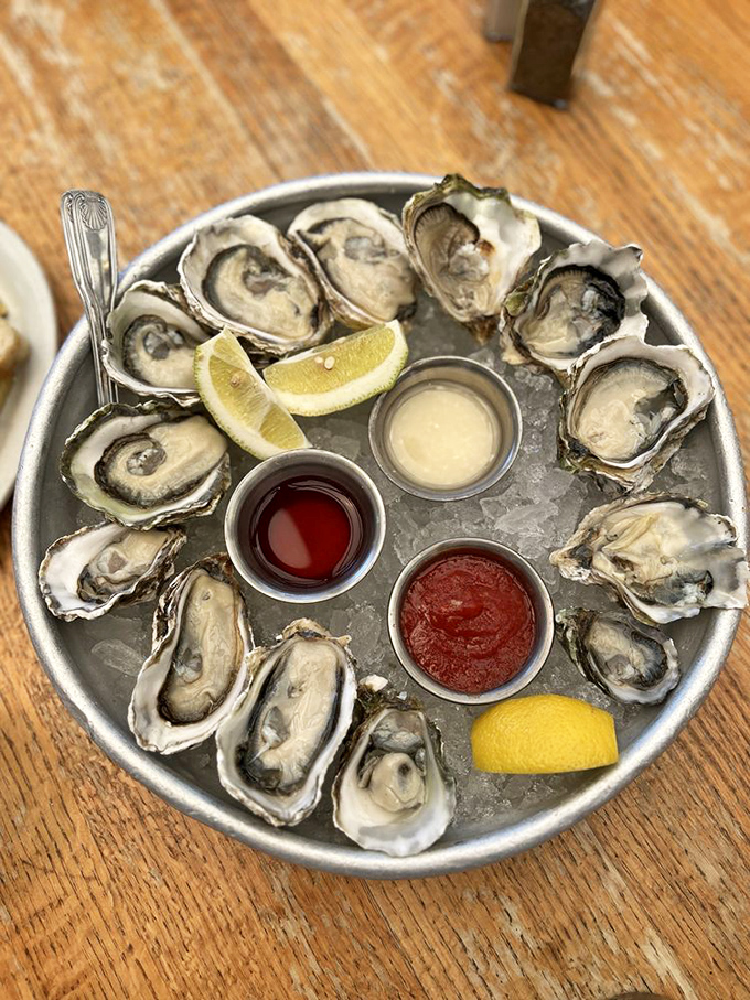 A dozen oysters arranged like a clock face of oceanic delight, with dipping sauces marking the perfect time to indulge.