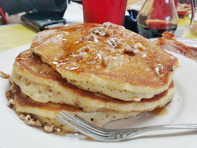 Pancakes stacked higher than your weekend expectations. Each fluffy layer promises maple-soaked happiness that no fancy brunch could ever replicate.