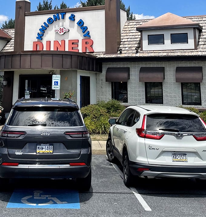 Even the parking lot tells a story&mdash;Knight & Day welcomes all, from Jeeps to Hondas. The "24" in the sign promises round-the-clock comfort.