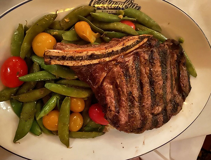 A ribeye that's clearly been introduced to fire under optimal circumstances, accompanied by vegetables that didn't just give up and become afterthoughts.