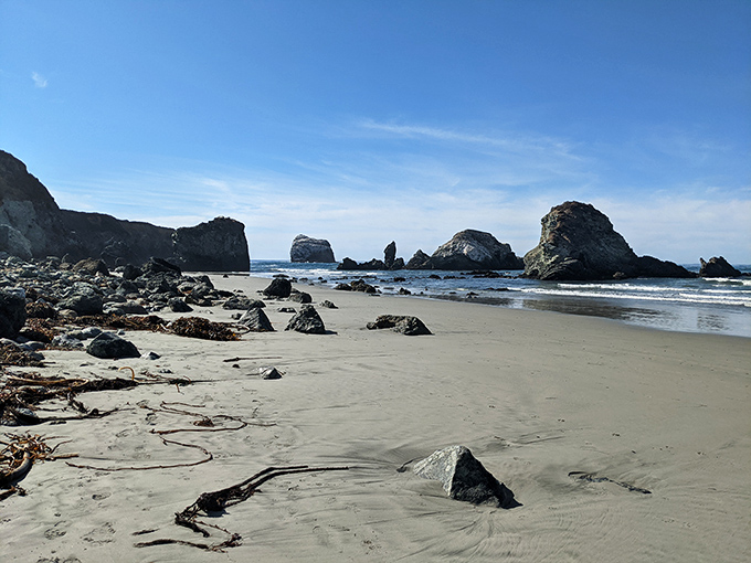 Scattered rocks create natural tide pools and private coves, turning a simple beach walk into a geological treasure hunt.