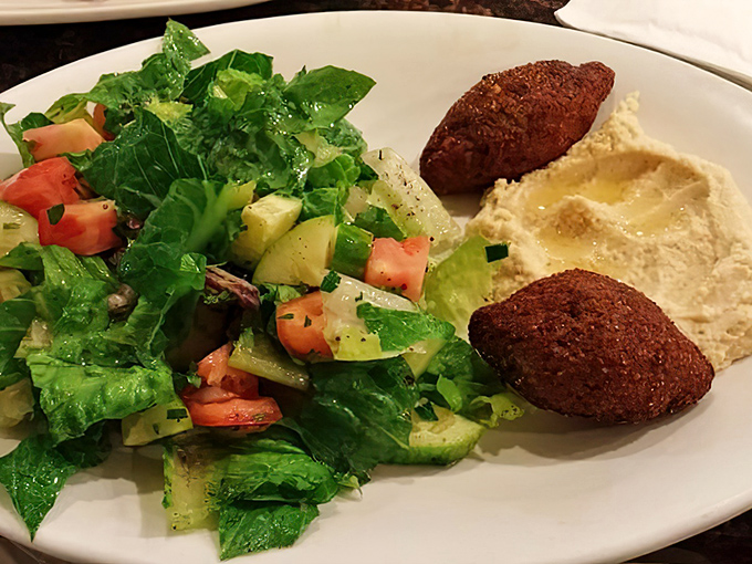 A fresh salad and falafel plate proving that diners can do healthy without sacrificing flavor—the Middle Eastern influence adding unexpected depth to the classic menu.