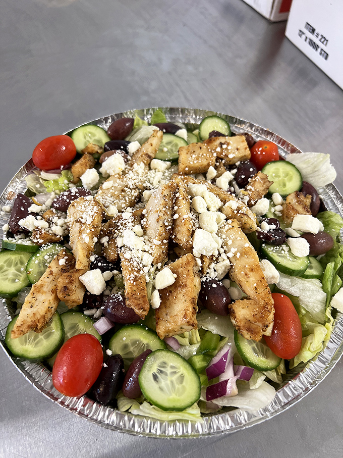 This Greek salad isn't just a healthy option—it's a Mediterranean vacation on a tin plate. Those olives are practically postcards from Athens.