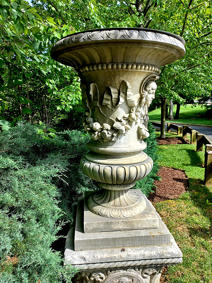 This ornate garden urn isn't just decorative—it's practically architectural sculpture. The stone faces seem to whisper secrets from the Gilded Age.