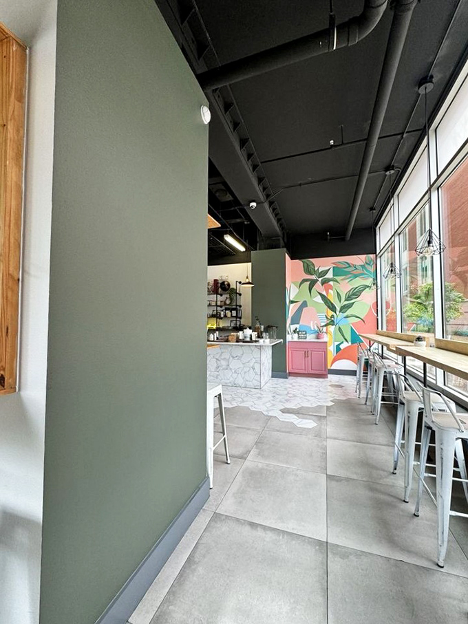 Industrial-chic meets tropical vibes with exposed ceiling details and a vibrant mural that makes waiting for your Problem Omelette a visual feast.