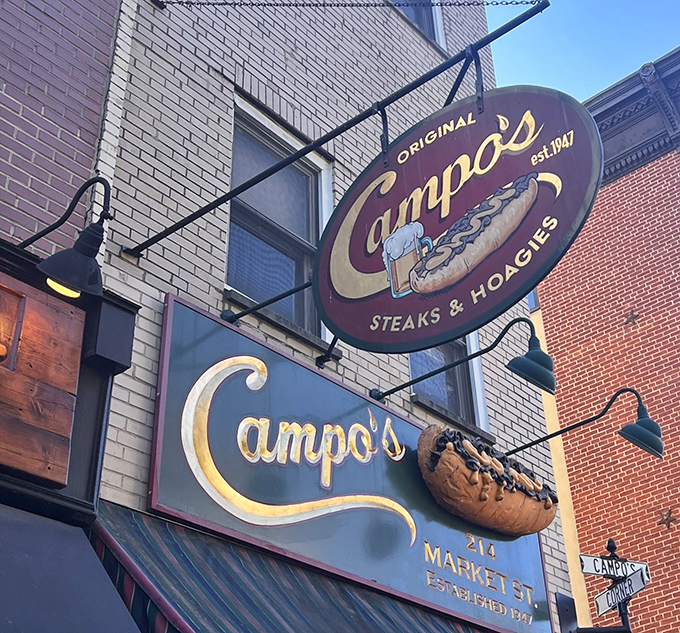 The circular sign swinging above Market Street has guided more hungry travelers than the North Star, a cheesesteak compass pointing to deliciousness.