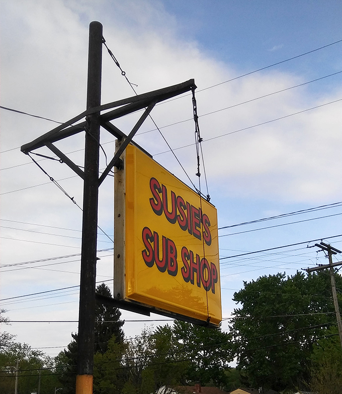 The roadside sign stands tall against the Ohio sky, a yellow beacon guiding hungry travelers to sandwich nirvana.
