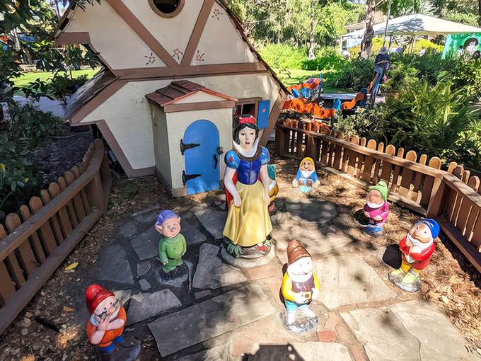 Snow White and her seven vertically-challenged friends welcome visitors to their meticulously landscaped storybook home.