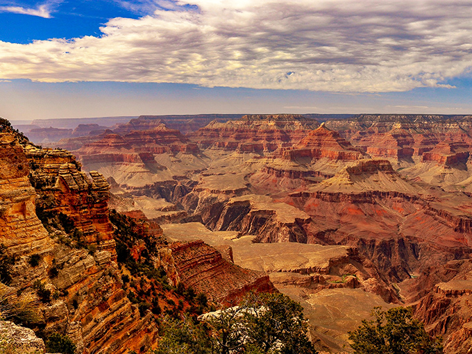 The Grand Canyon unfolds its impossible vastness, a view so overwhelming it makes philosophers of us all, if only for a moment.