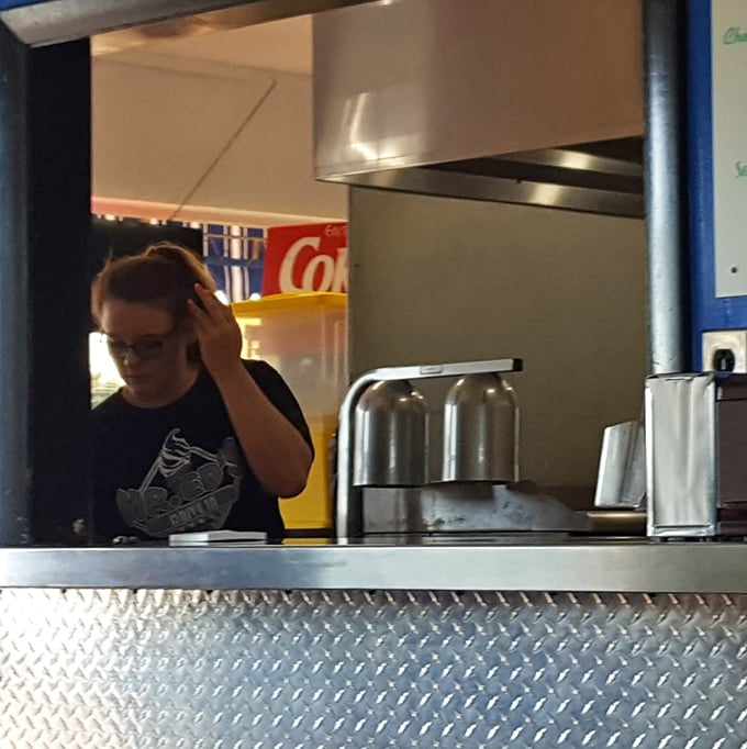 Behind the counter, where burger magic happens and friendly faces turn simple ingredients into memorable Missouri meals.