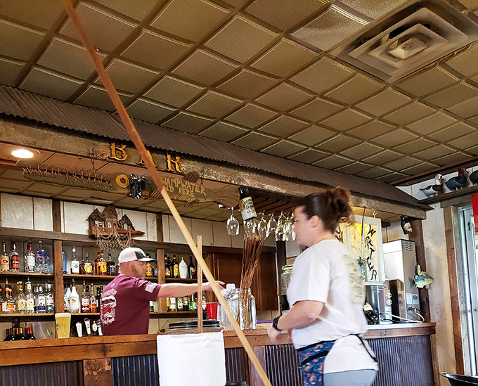 Where magic happens: a staffer navigating the well-worn bar with the confidence that comes from serving generations of seafood lovers.
