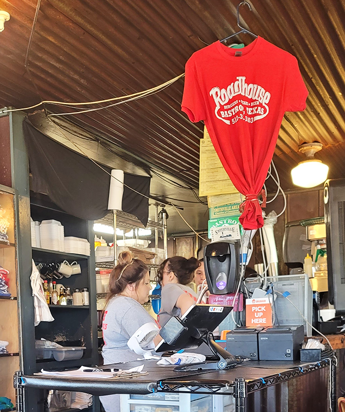 The beating heart of any great restaurant&mdash;staff who move with practiced efficiency while a red Roadhouse t-shirt stands sentinel overhead.