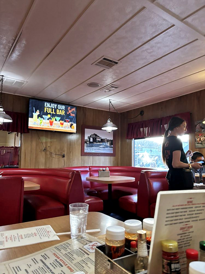 That perfect diner moment: red booths, wood paneling, and servers who've mastered the art of appearing exactly when you need them.