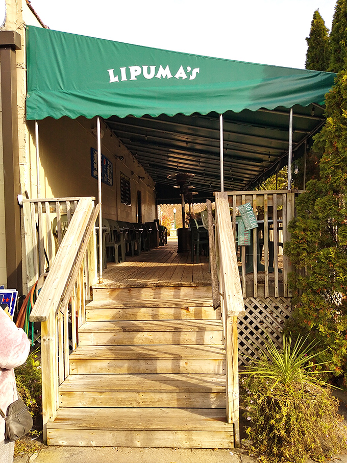 The green awning marks the spot! This wooden stairway has welcomed countless hungry pilgrims to Lipuma's outdoor dining sanctuary.