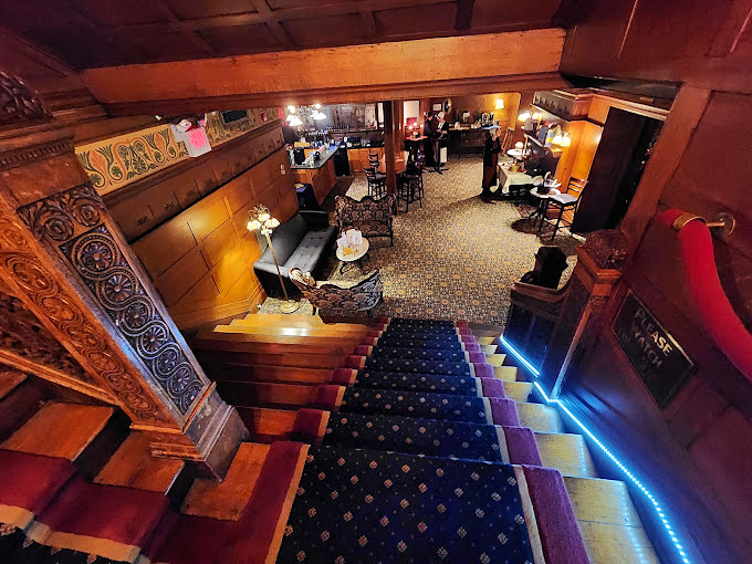 The grand staircase descends to a bar area that feels like the world's most elegant speakeasy, where Prohibition is just a distant, unpleasant memory.