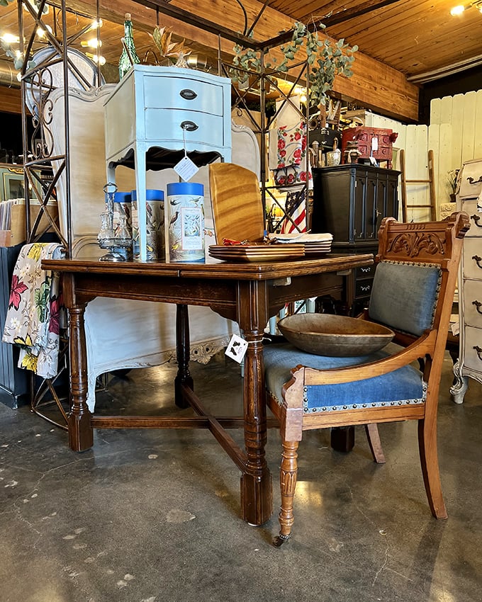 Mid-century meets farmhouse in this tableau of wood tones and textures. That blue nightstand adds just the right pop of color.